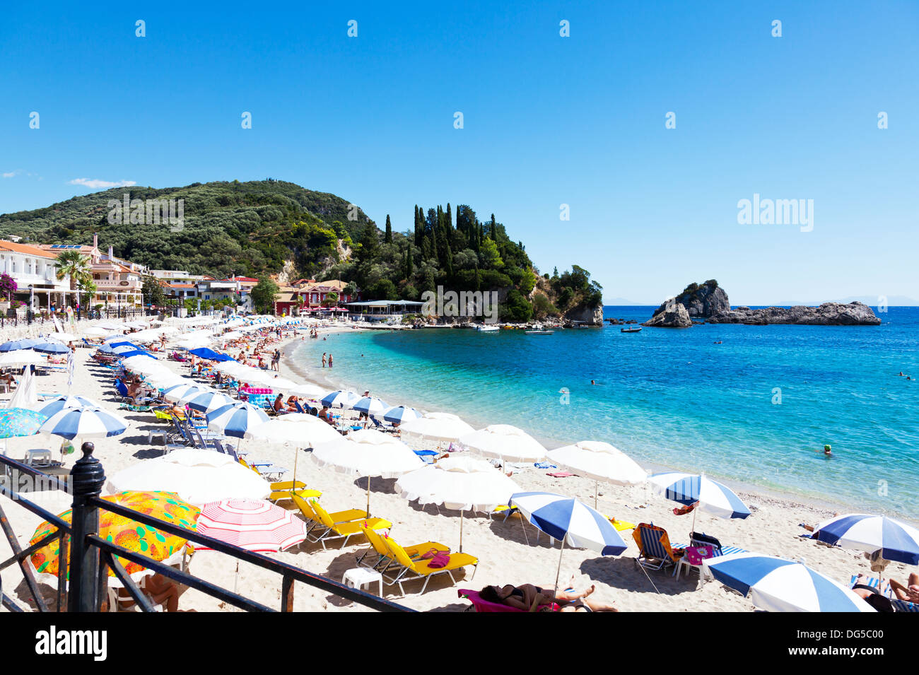 Parga town beach summer parasols sunbathers sun sunny tourists Greek ...