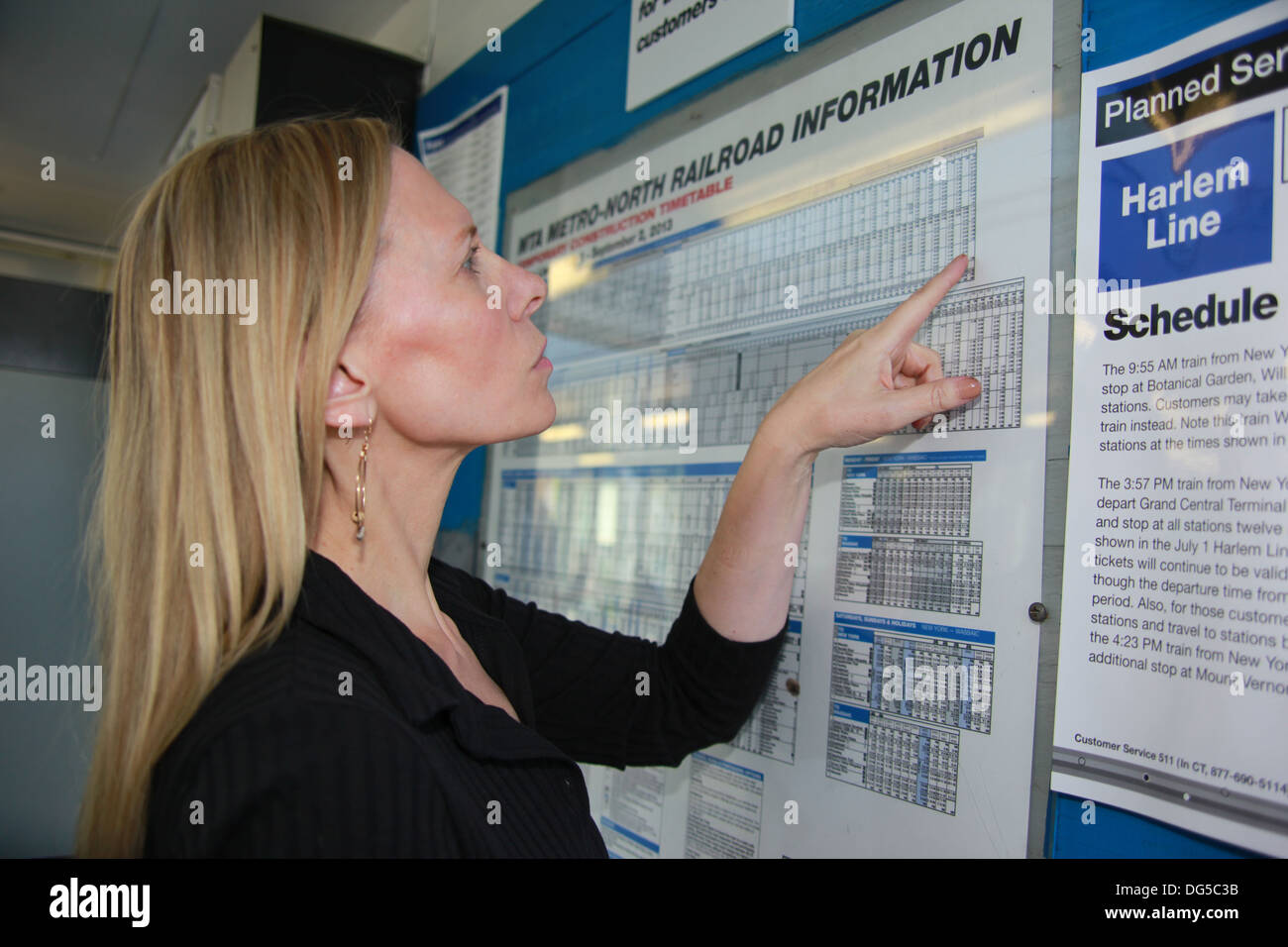 Checking train timetable hi-res stock photography and images - Alamy