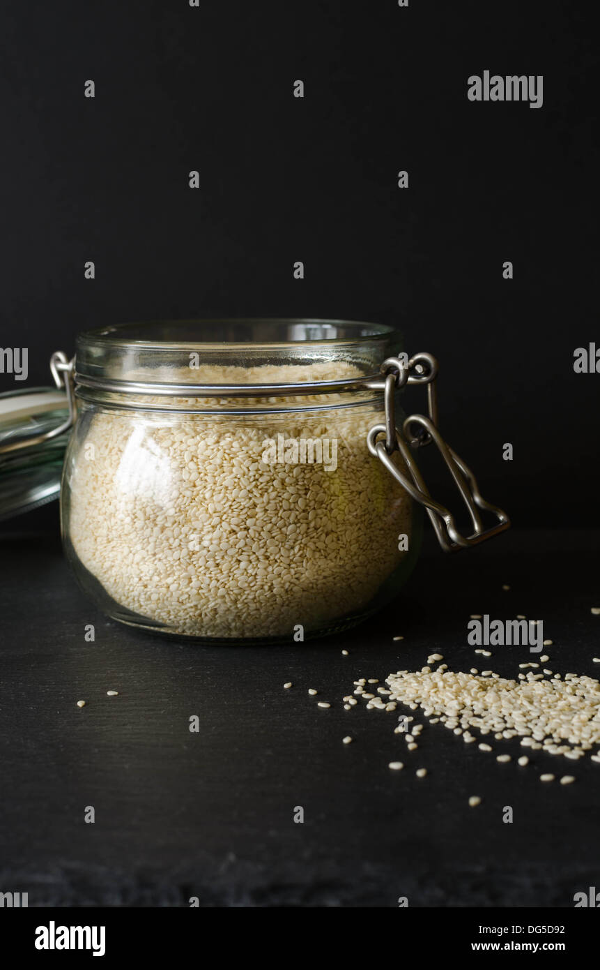 Sesame seed in a jar, black background Stock Photo - Alamy