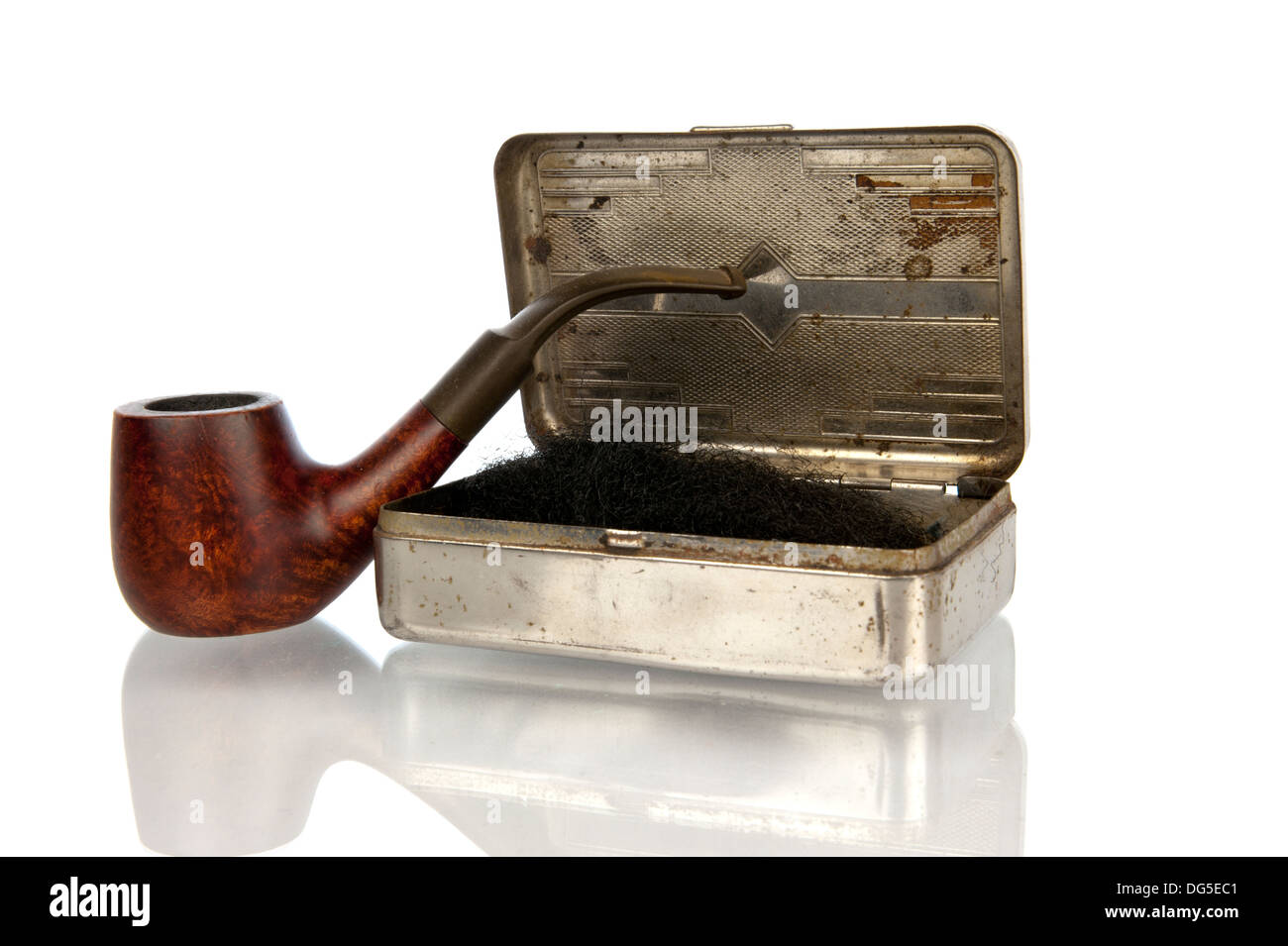 Vintage brown pipe with filled iron tobacco box in closeup and isolated ...