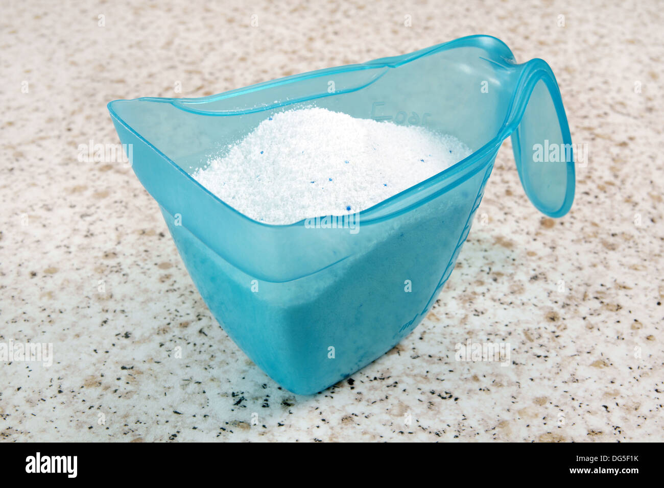 Laundry detergent or washing powder in a blue measuring cup on a kitchen counter top Stock Photo Alamy