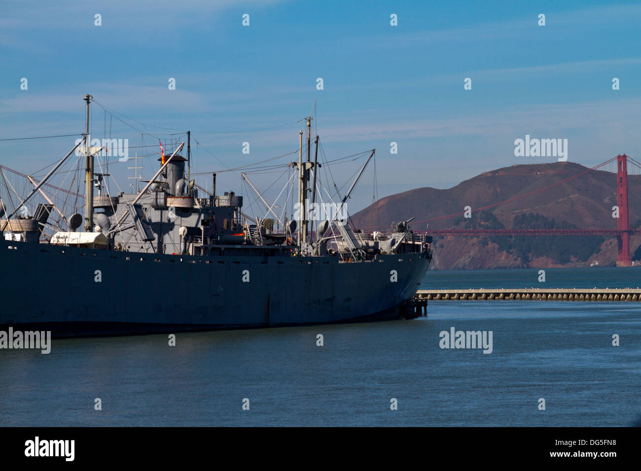 A U.S. Navy ship docked in San Francisco Bay with a view of the Golden ...