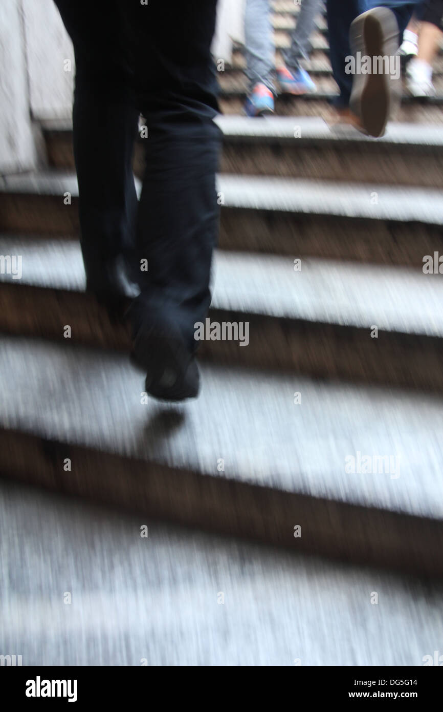 people walking up steps in city town Stock Photo - Alamy