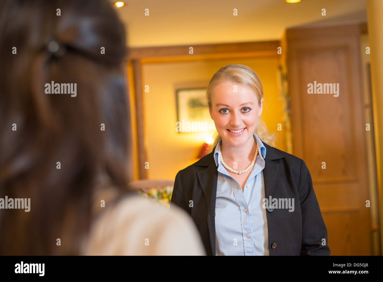 young woman at hotel reception Stock Photo - Alamy