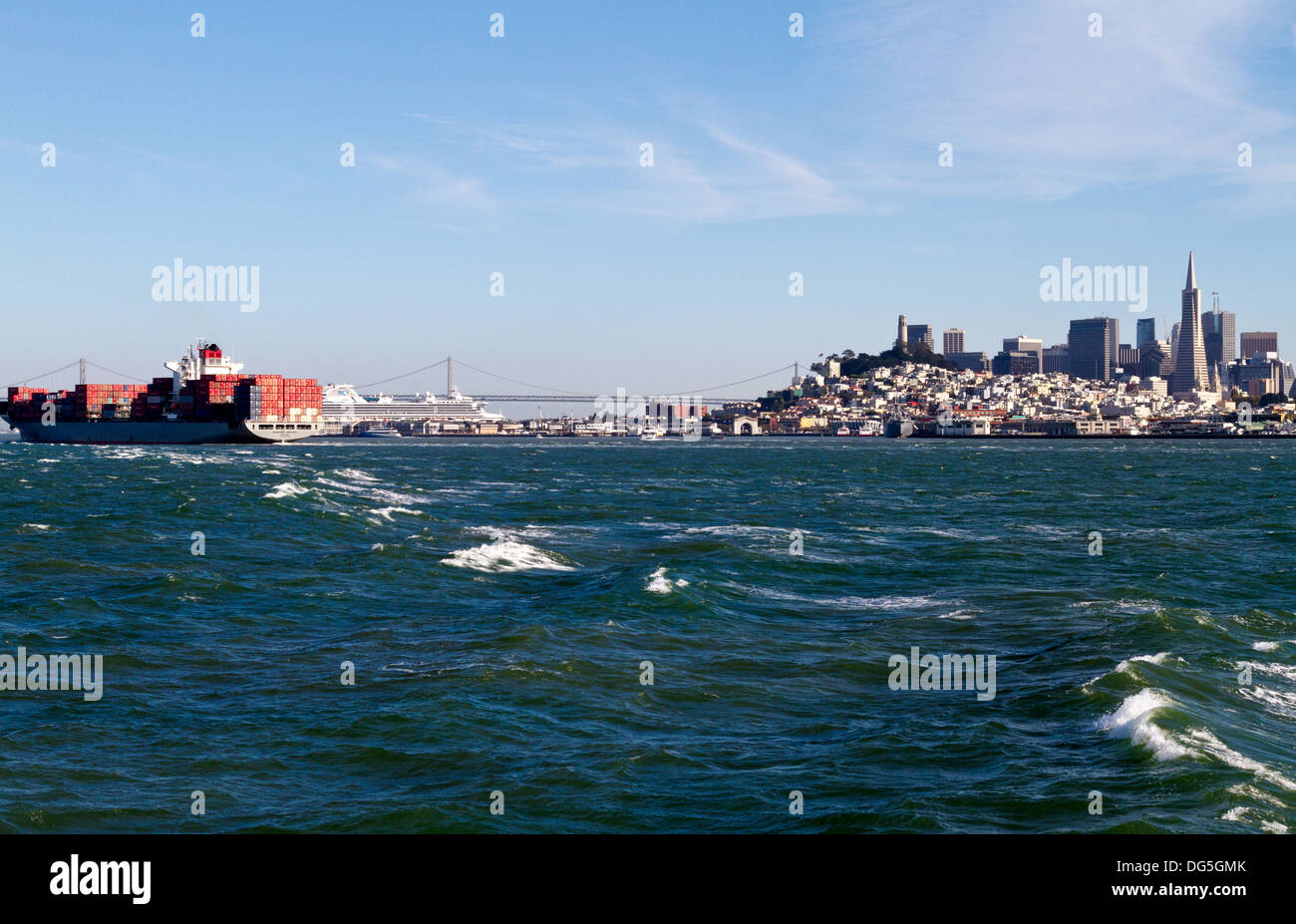 Container ship on San Francisco Bay with city and Bay Bridge in ...