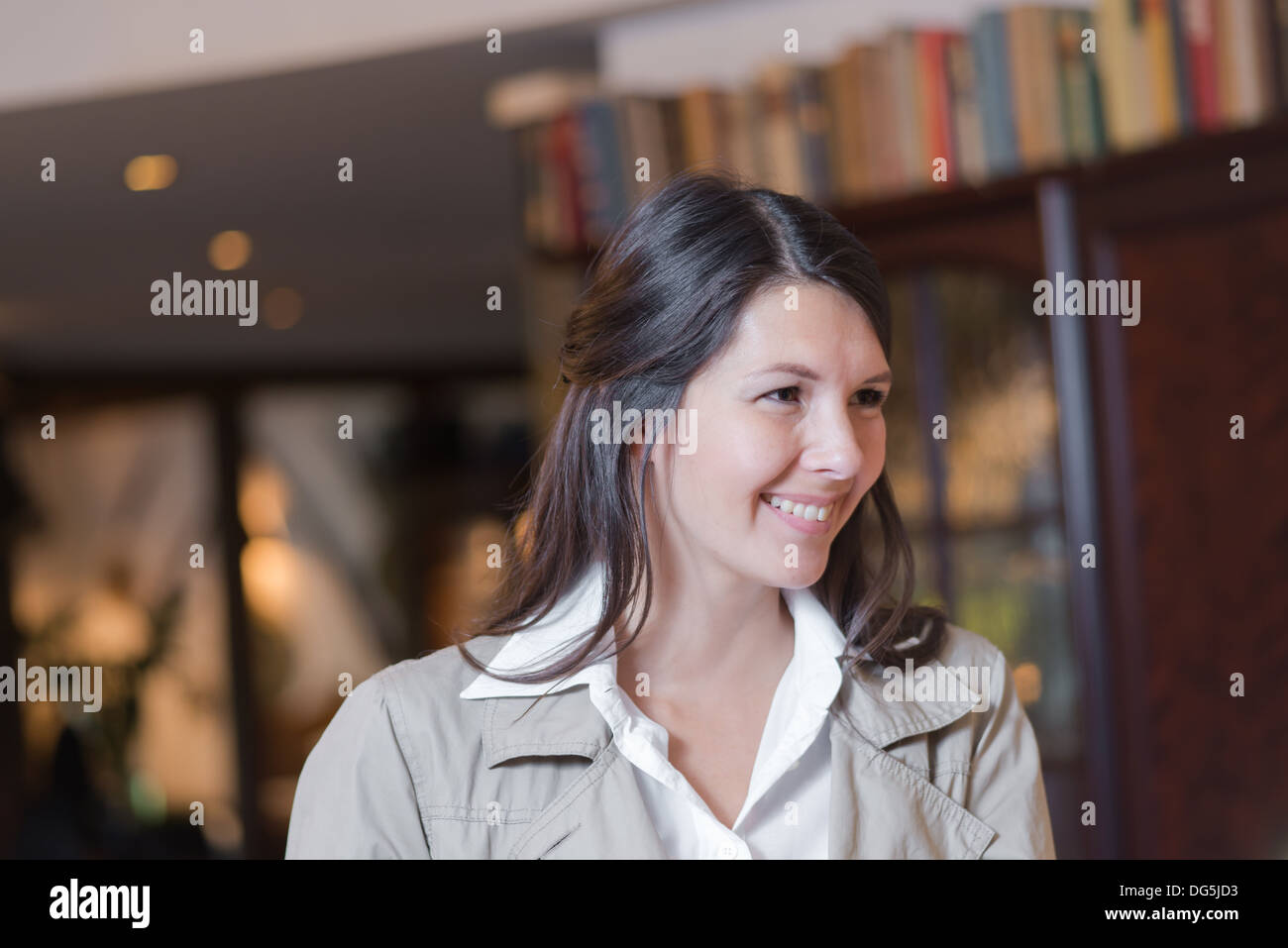 smiling female hotel guest at hotel reception Stock Photo - Alamy