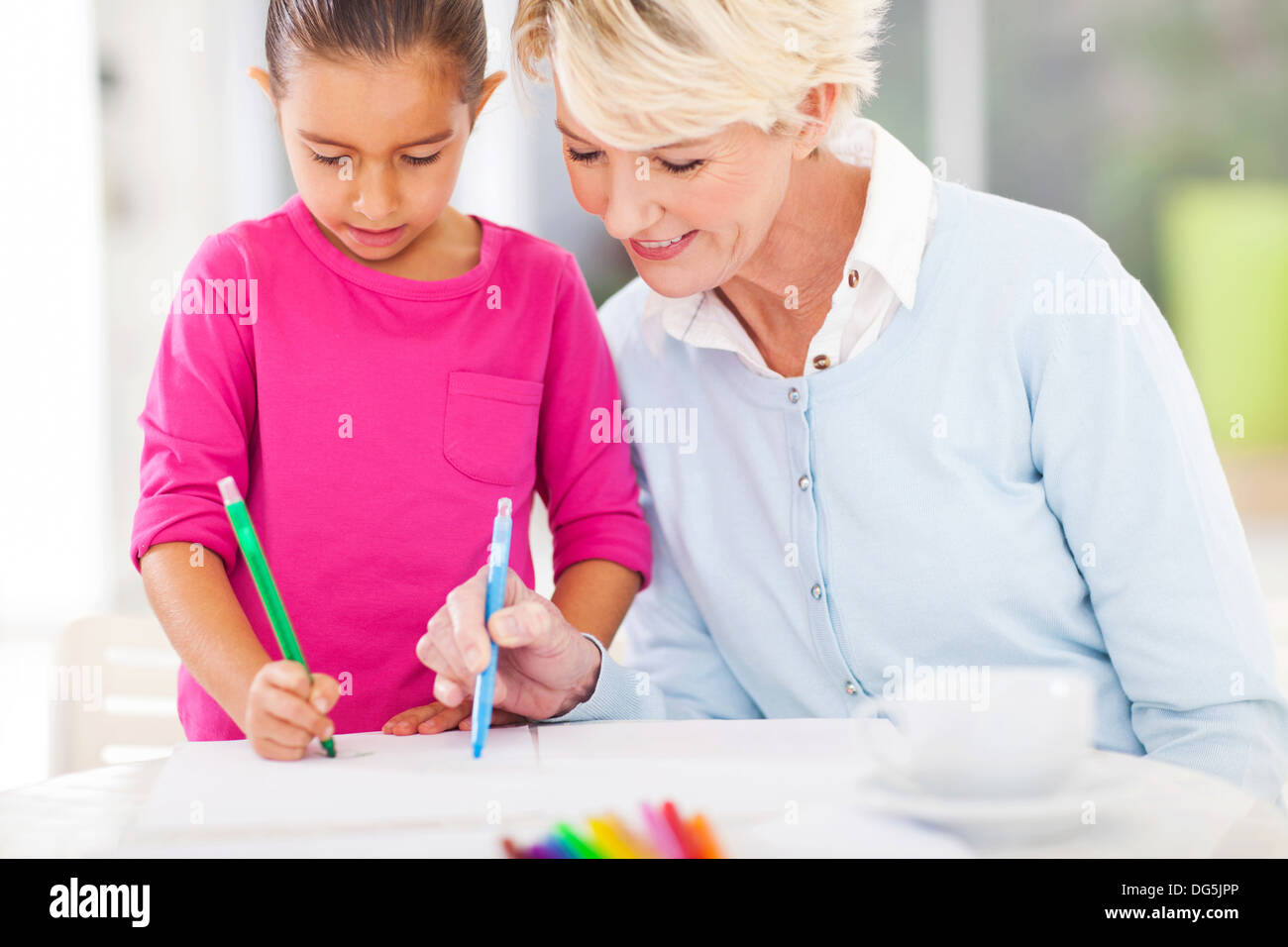 loving grandma teaching granddaughter drawing at home Stock Photo - Alamy
