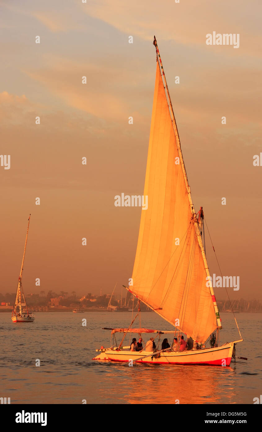 Felucca boat sailing on the Nile river at sunset, Luxor, Egypt Stock ...