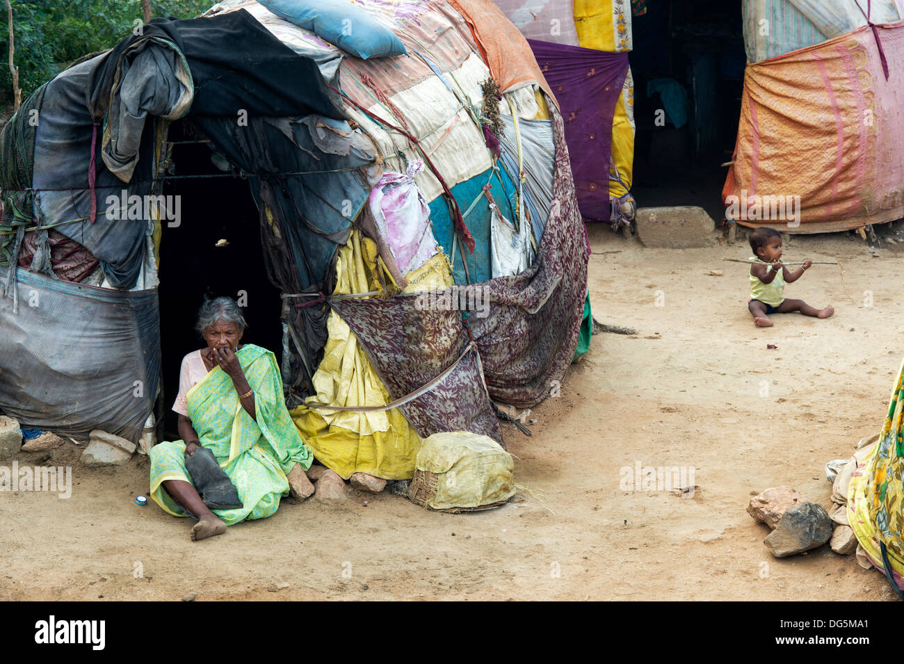 Lower caste Indian woman sitting outside her bender / tent / shelter ...