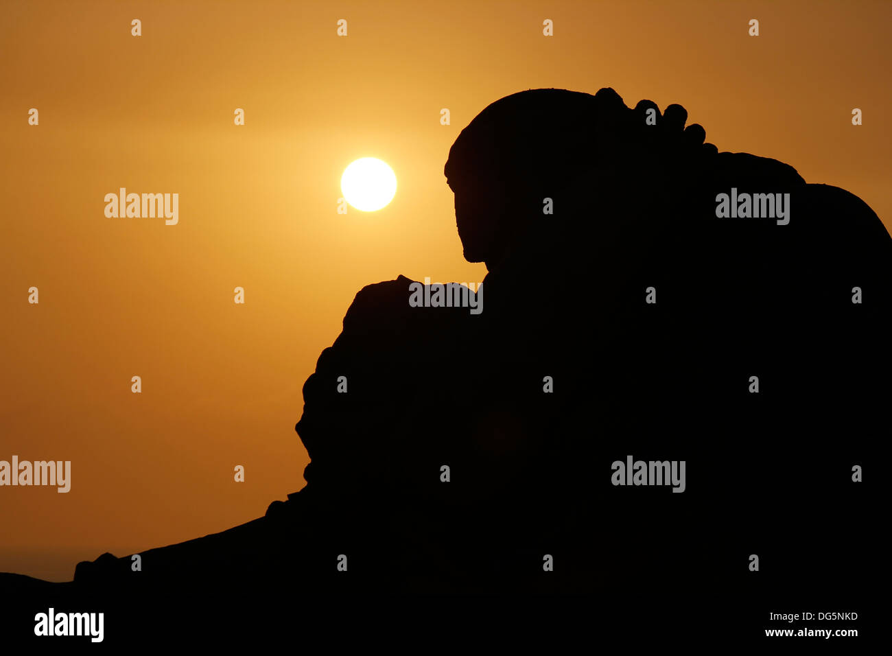 Silhouette of sculpture "The Kiss" ("El Beso") at sunset, Parque del ...