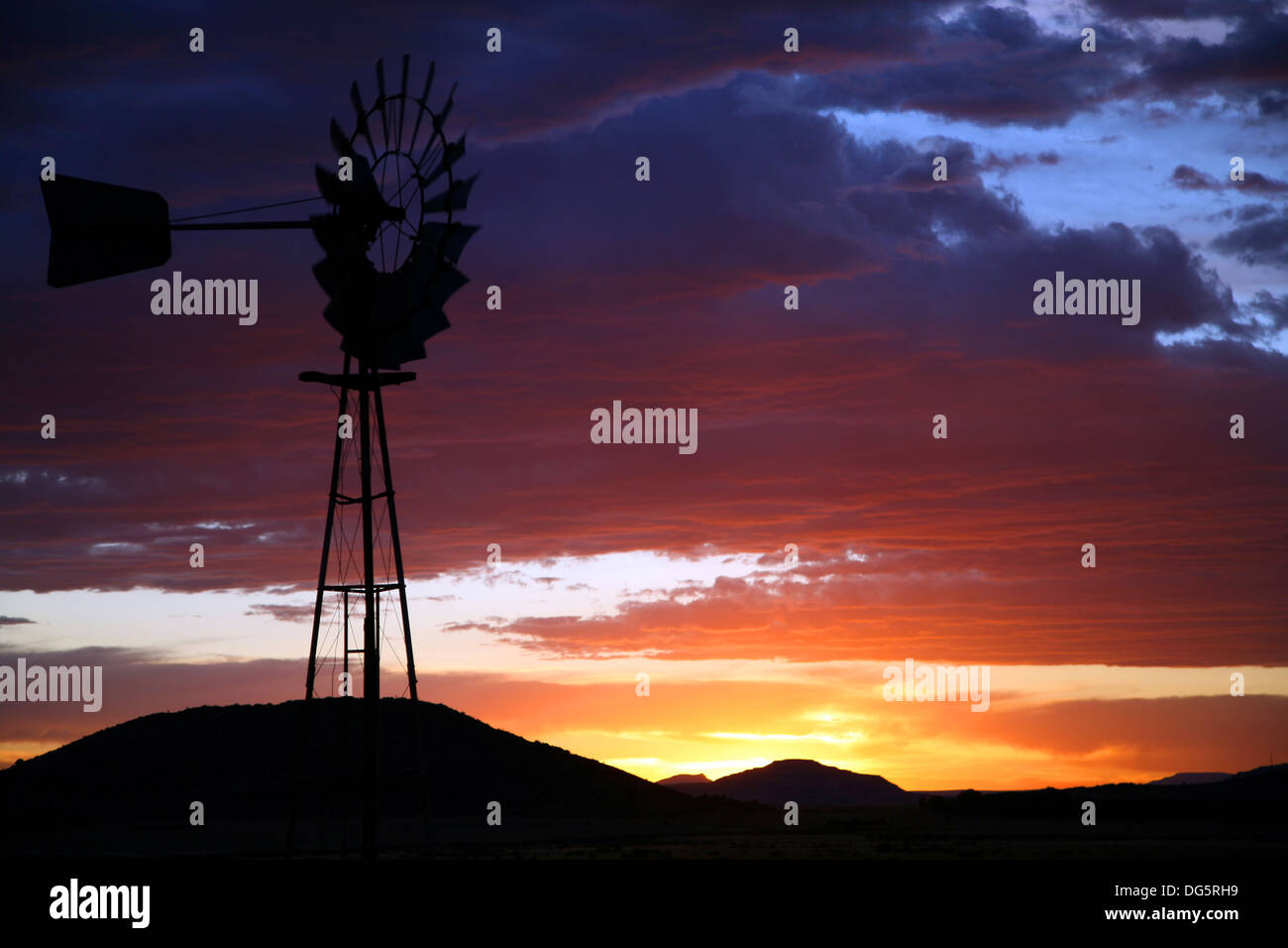 Old Farm Windmill for Pumping Water with Spinning Blades at Sunset in ...