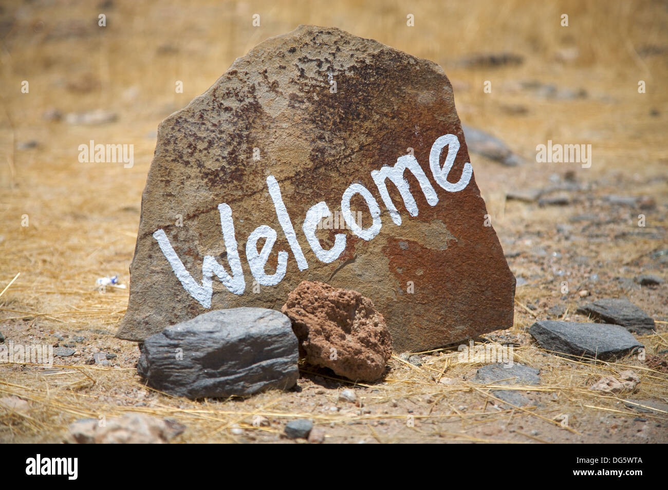 Welcome message written on a rock at the entrance of a national park in ...