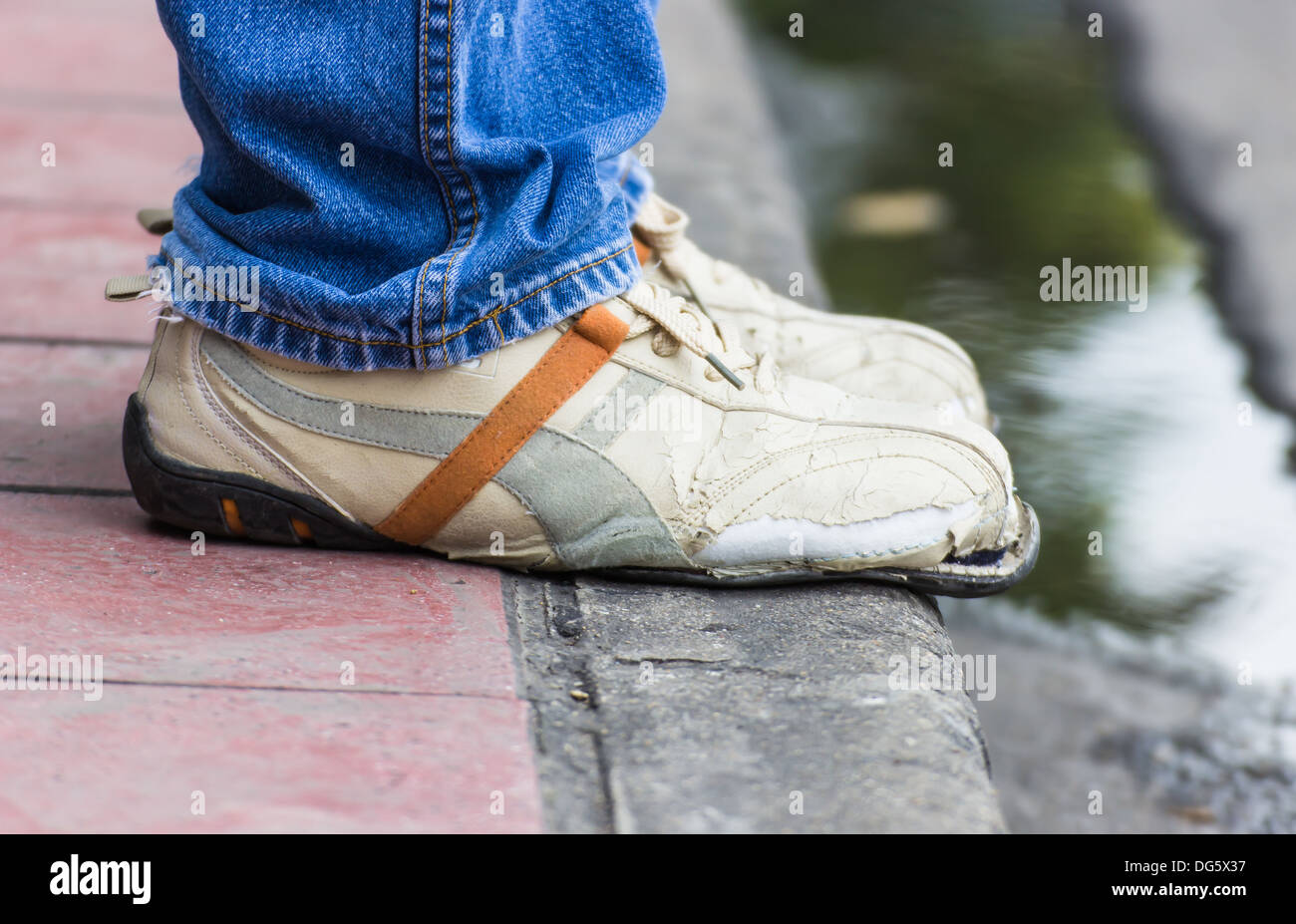 Ripped shoes, waiting someone at a bus stop in Bangkok, Thailand Stock ...