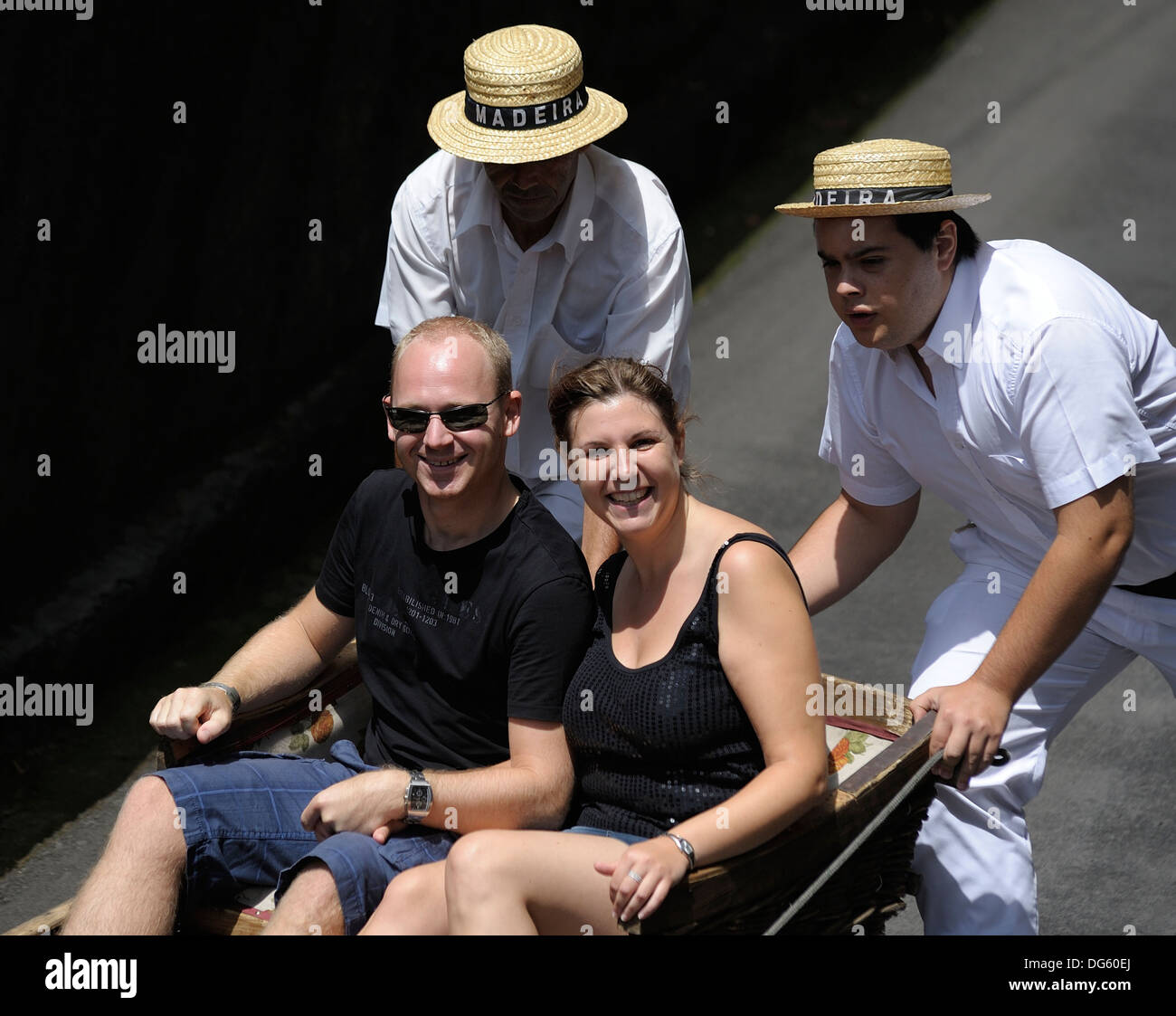 Monte Madeira Portugal,a happy young couple enjoying the toboggan ride ...