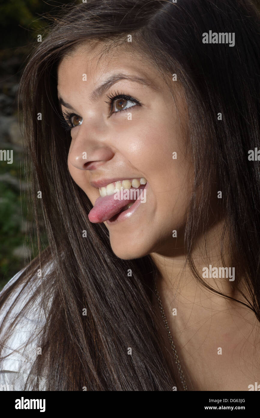 Portrait female teenager sticking out tongue hi-res stock photography ...