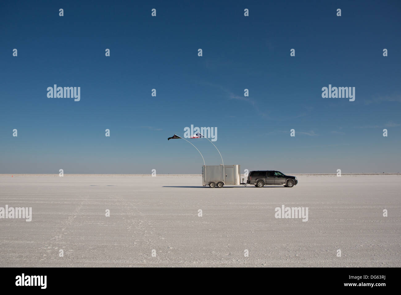SUV driving with trailer at Bonneville Salt Lake Flats Stock Photo - Alamy
