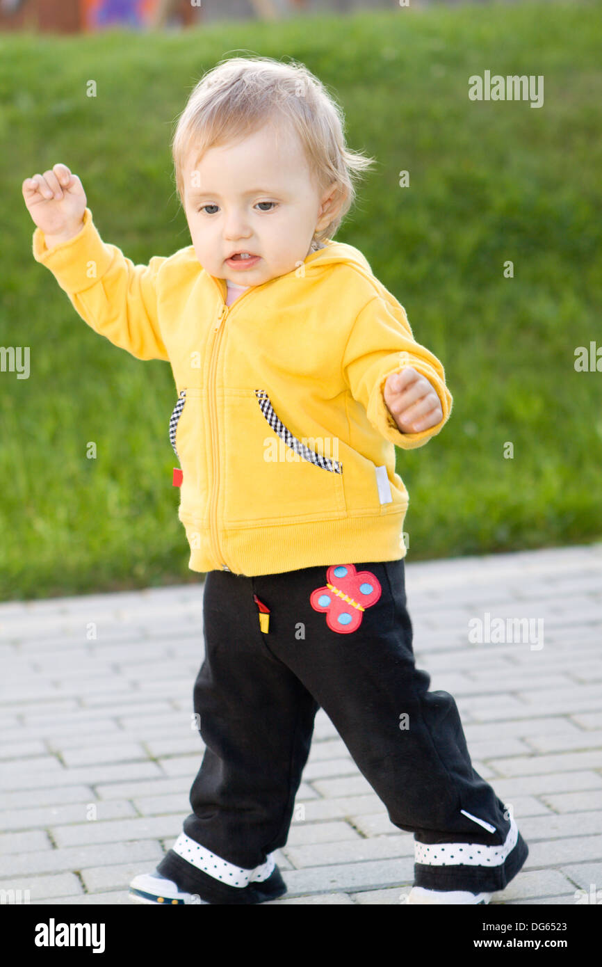 Sweet baby girl walking outdoor Stock Photo - Alamy