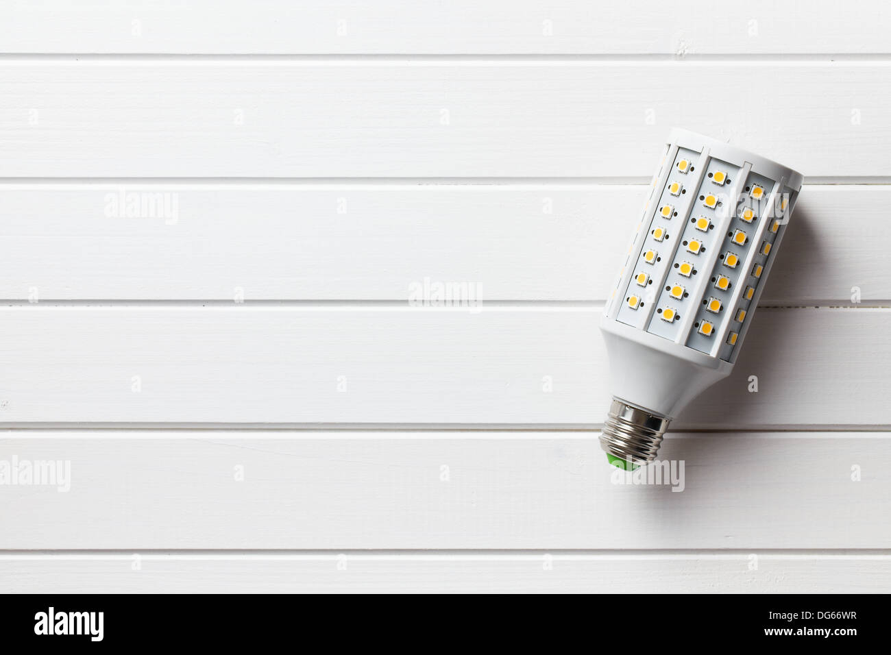 top view of LED light bulb on white wooden background Stock Photo - Alamy