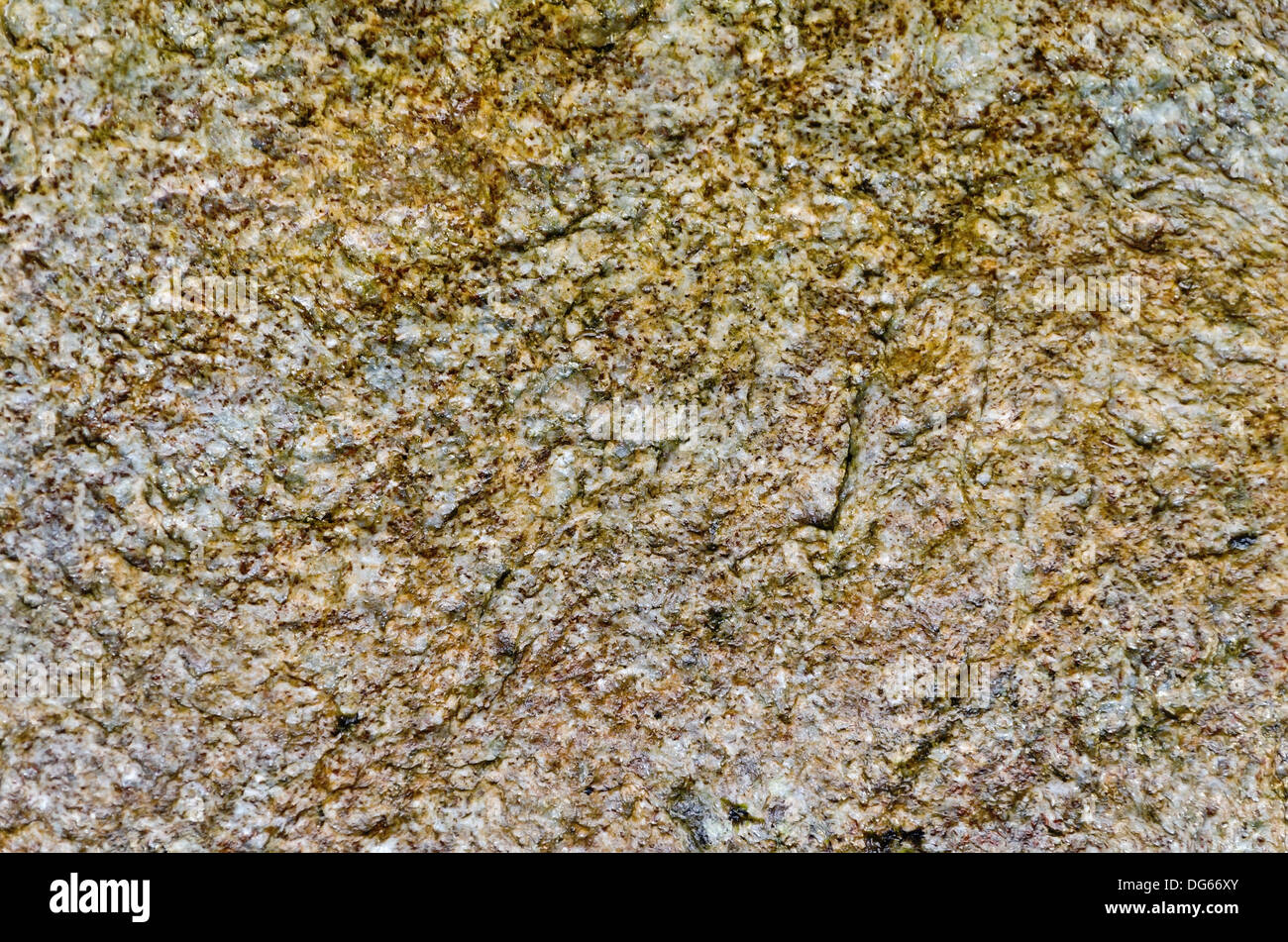 The texture of natural spotty brown, yellow and gray granite stone ...