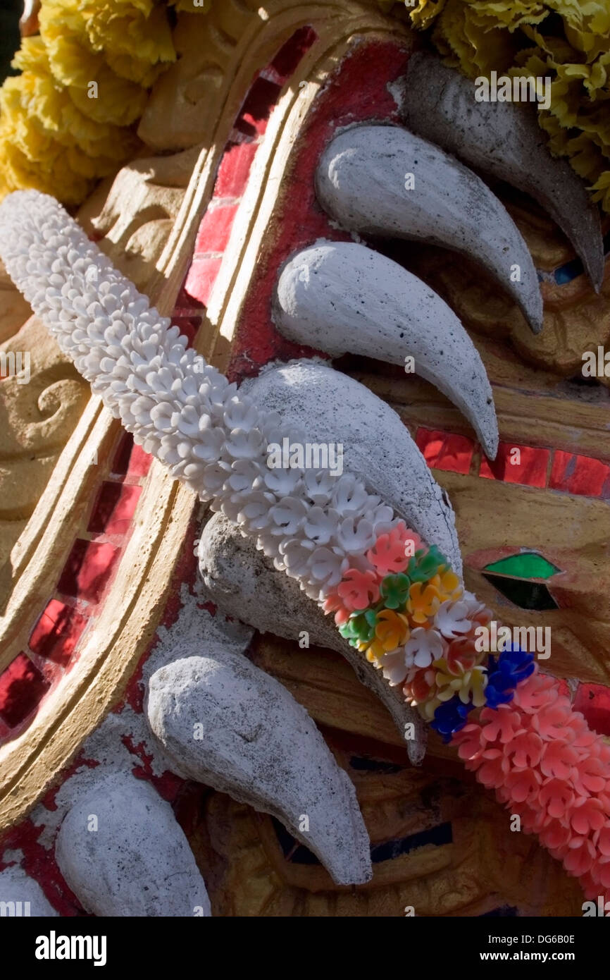 A beautiful floral lei is on display at the entrance to a Buddhist ...