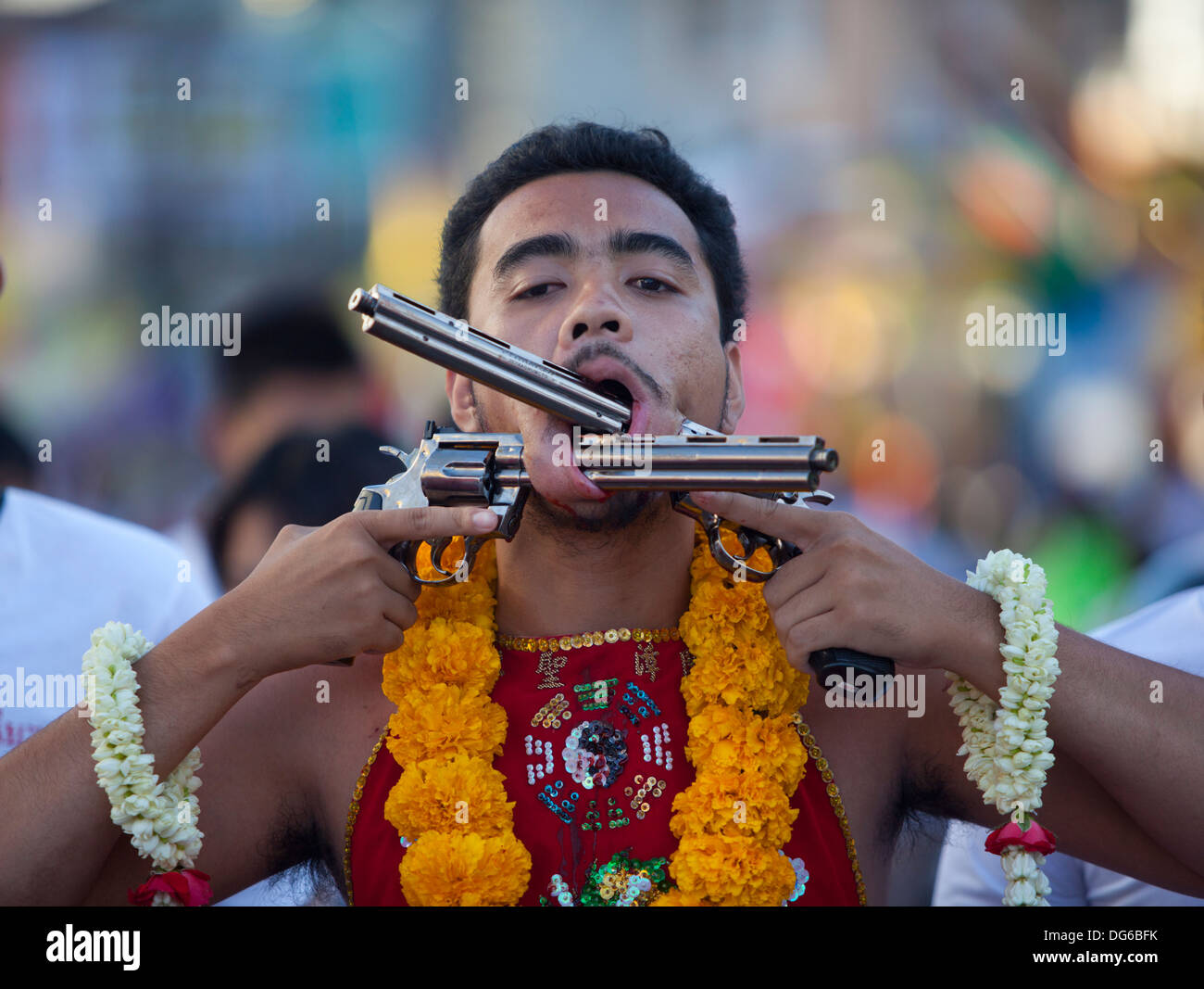 A Spirit medium walks in a street procession at the Phuket Vegetarian ...