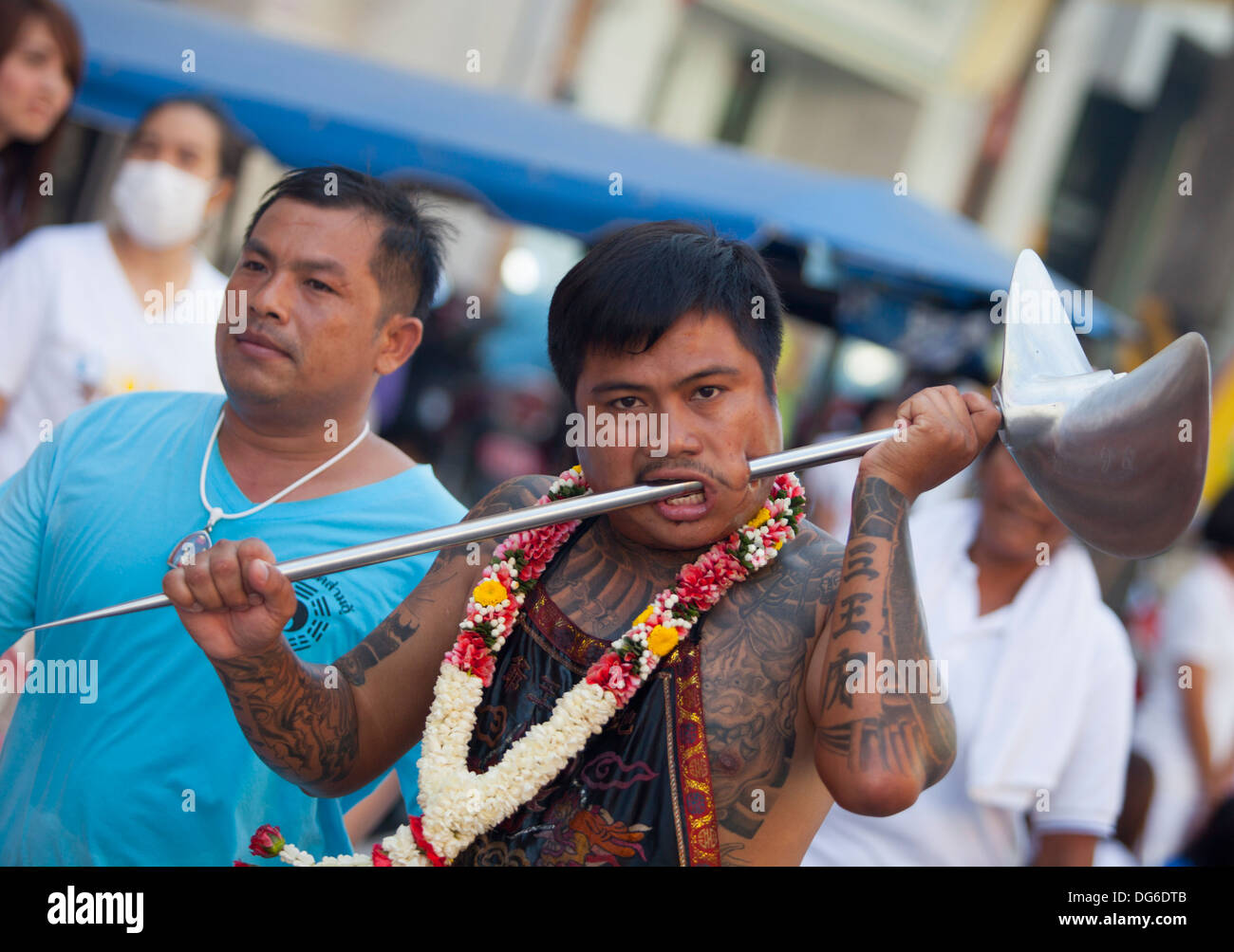 A Spirit medium walks in a street procession at the Phuket Vegetarian ...