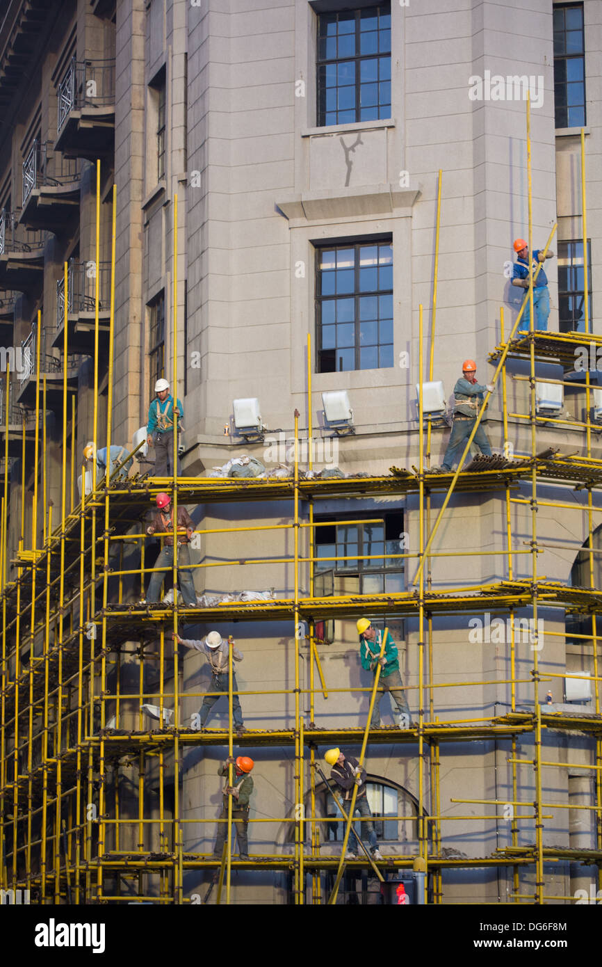 group of workers scaffolding a Classical building in the Bund - facing ...