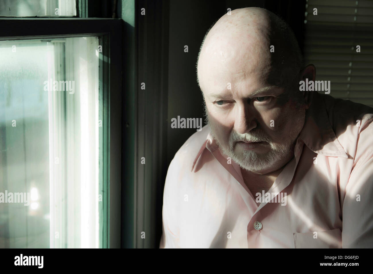 Older man by a window Stock Photo - Alamy