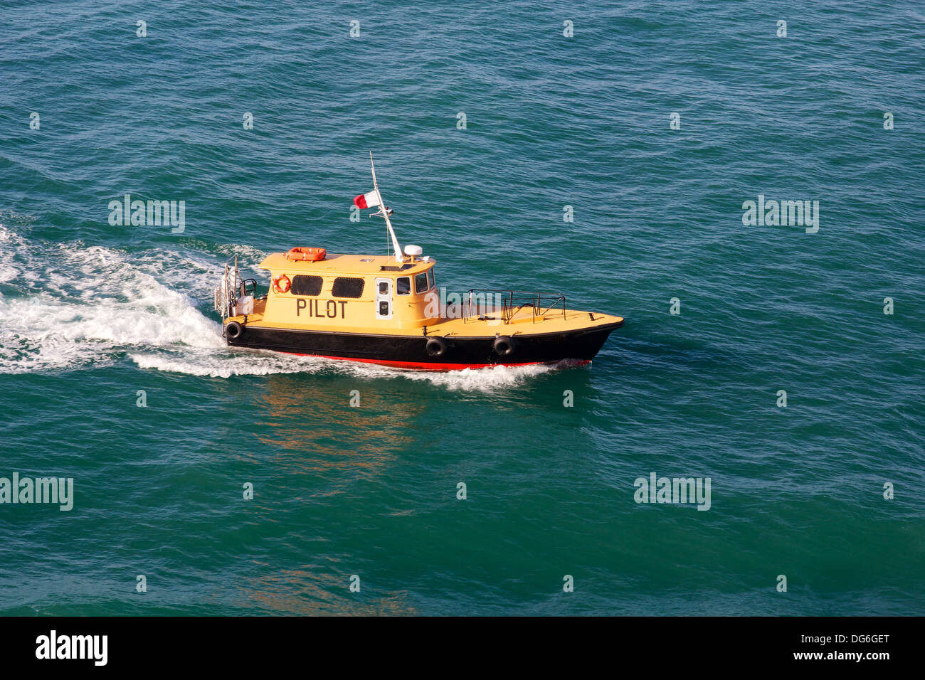 Yellow pilot boat steaming through the Caribbean sea near the harbor of ...