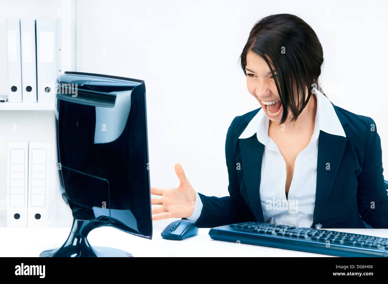 Business woman yelling at the monitor Stock Photo - Alamy