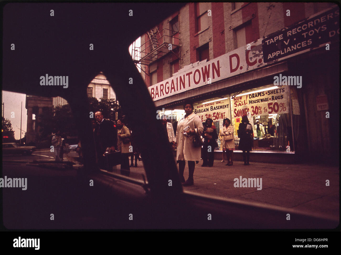 This image depicts a bus stop in downtown Washington, D.C., showing ...