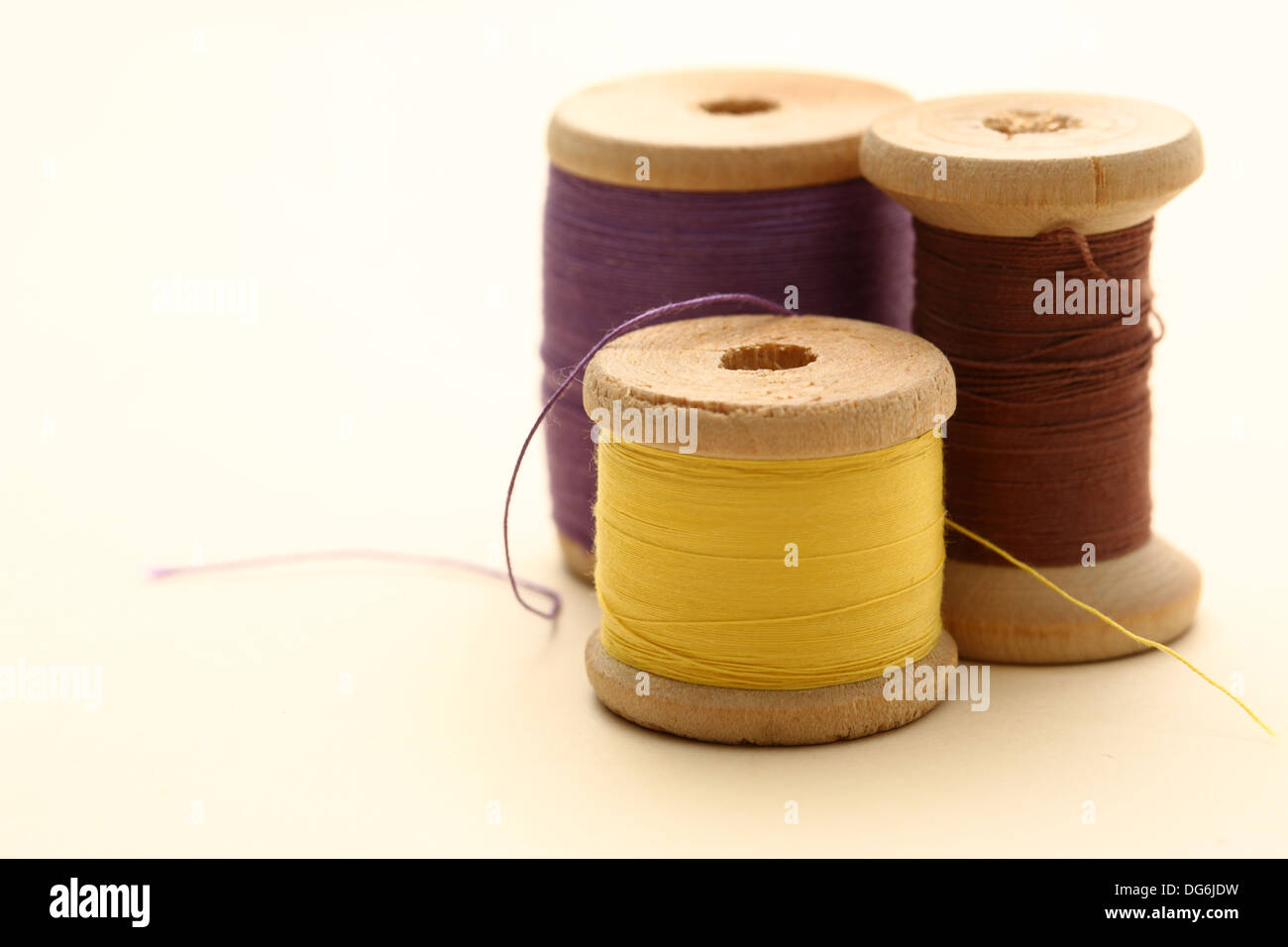 Thread bobbins on white background Stock Photo - Alamy