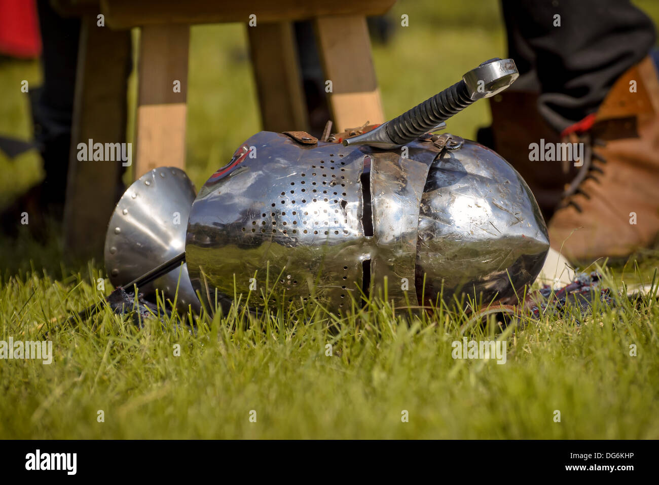 Helmet of the medieval knight and the sword on the green field Stock ...