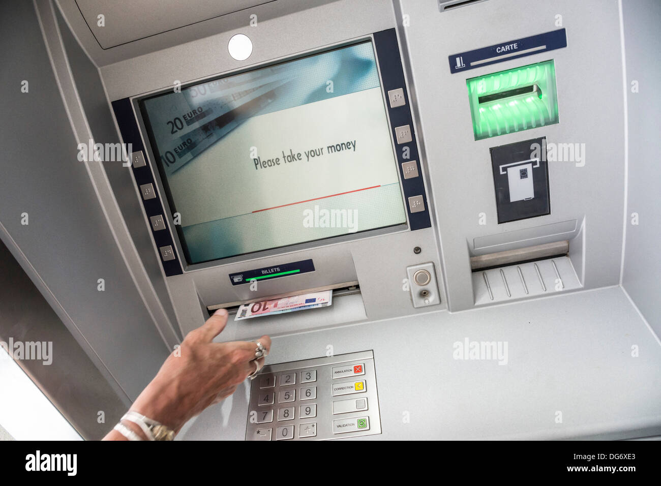 Getting Euro money from an ATM in France Stock Photo - Alamy