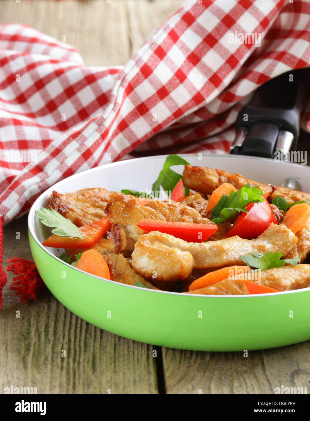 fried chicken (turkey) fillets with vegetables in a pan Stock Photo - Alamy