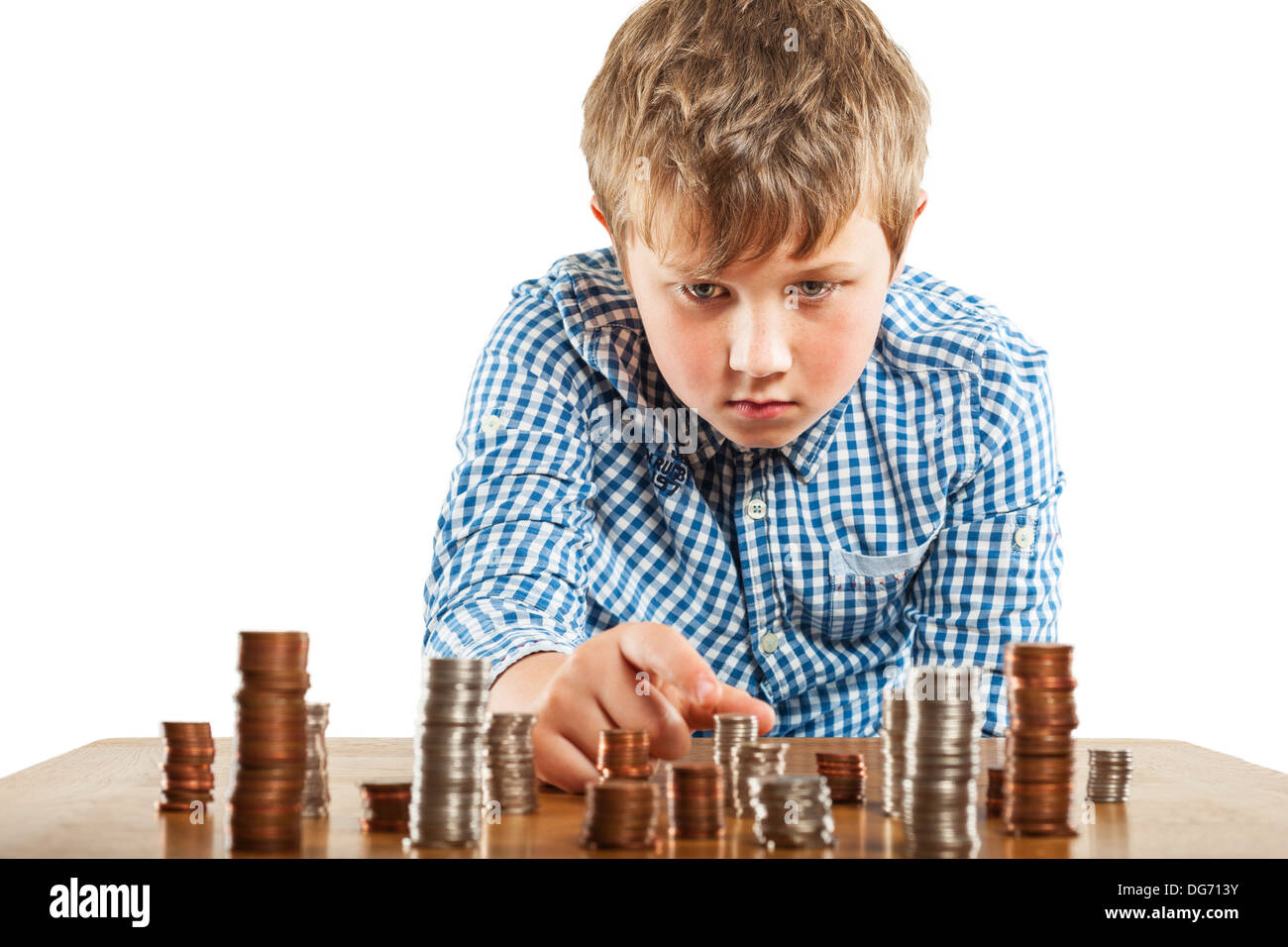 A young boy of 10 counts his money and stacks it up Stock Photo - Alamy