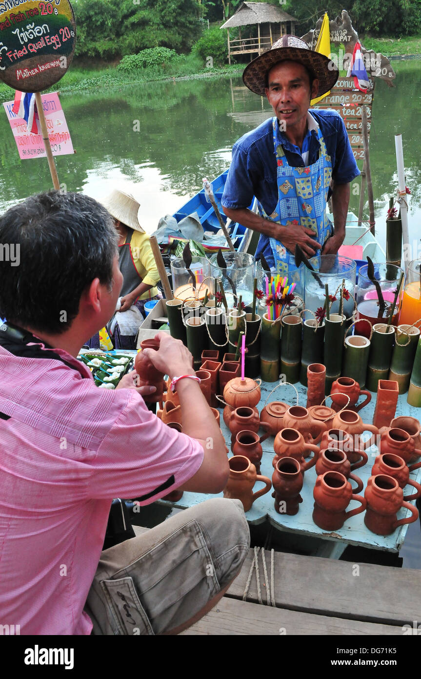 A man selling drinks from his boat at the Hatyai's Klong Hae Floating ...