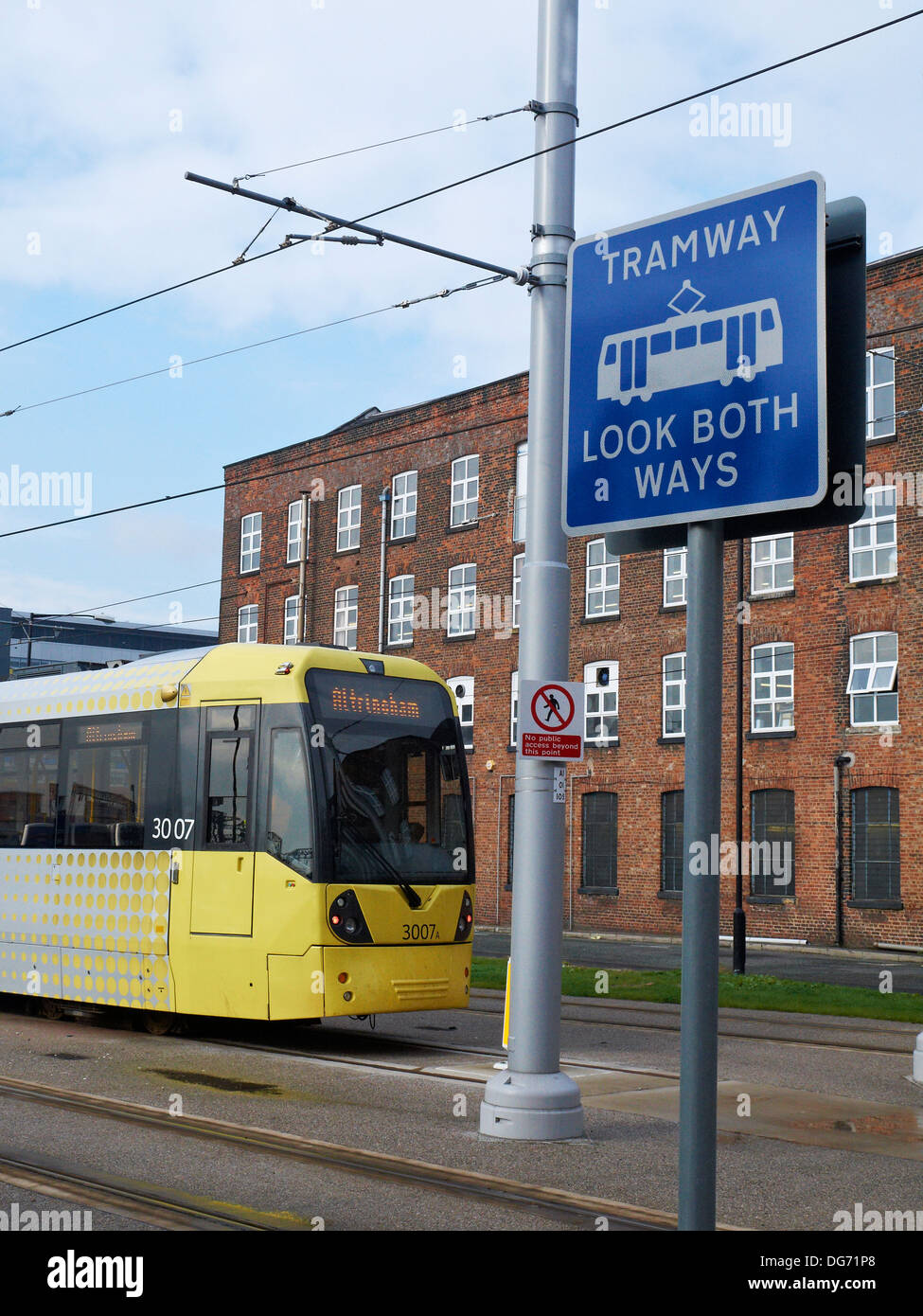 Tram with look both ways warning traffic sign in Manchester UK Stock ...