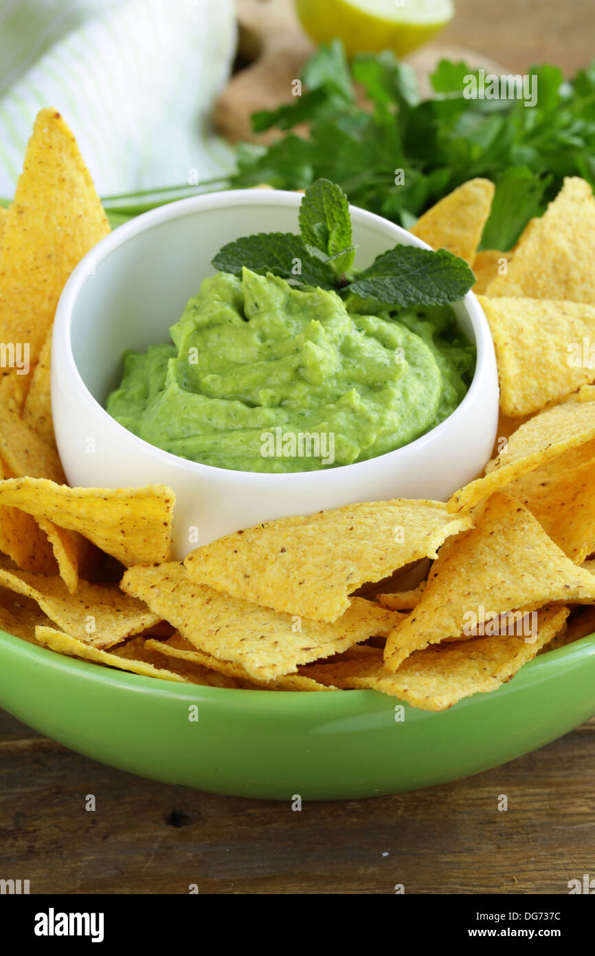 cup with guacamole and corn chips - traditional Mexican appetizer Stock ...