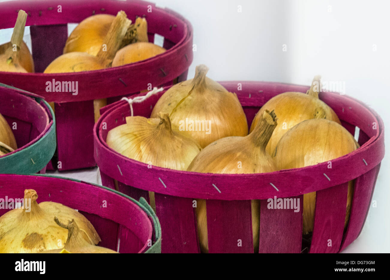 magenta baskets of onions at the county fair Stock Photo - Alamy