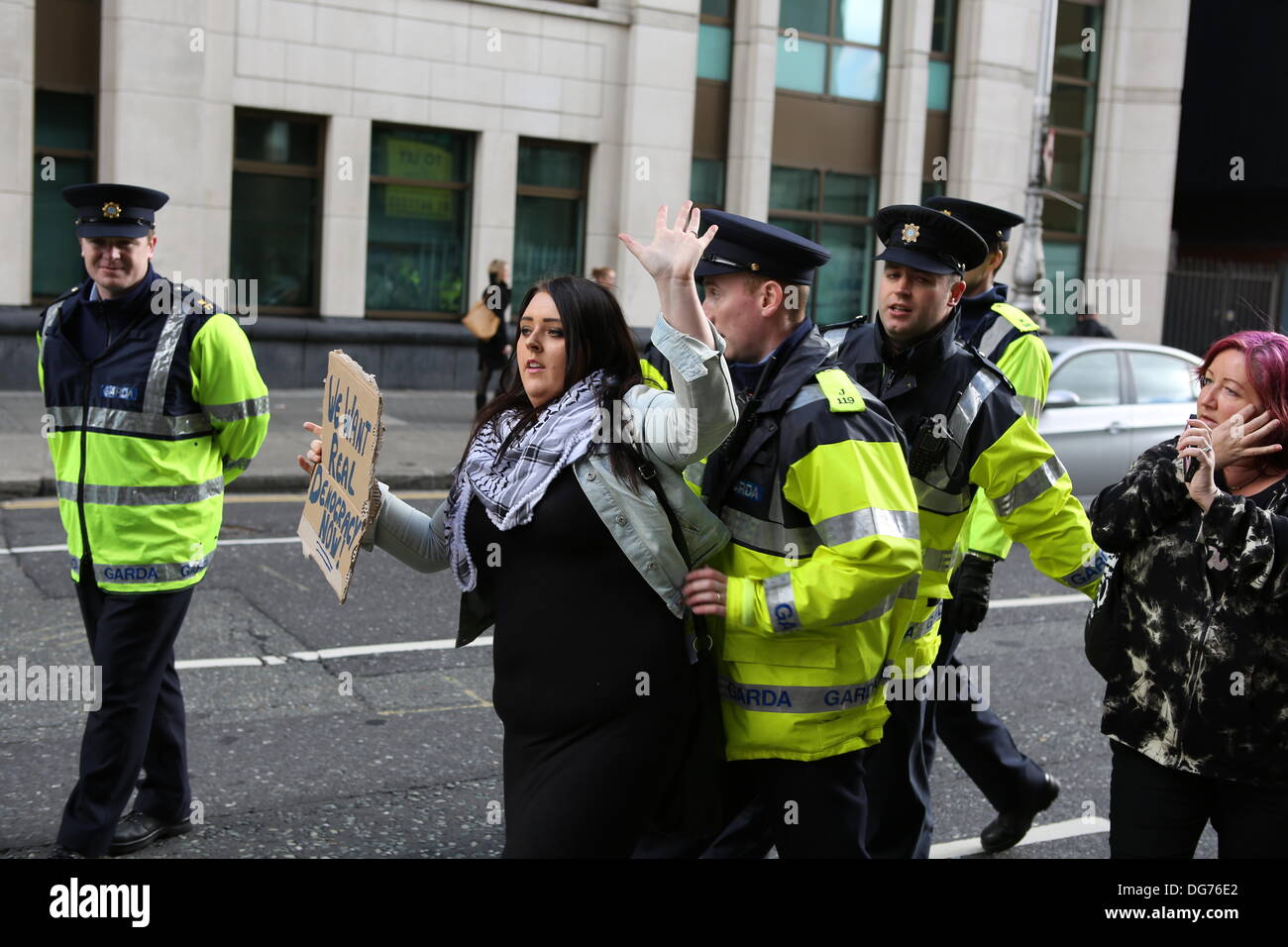 Dublin, Ireland. 15th October 2013. A protester is moved off the street ...