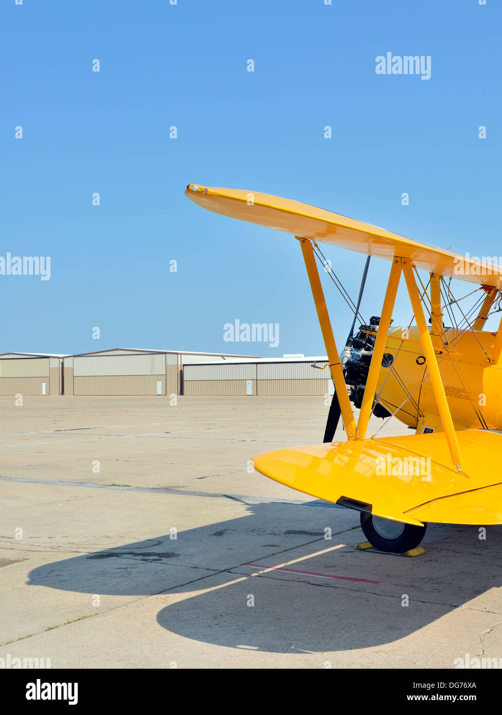 Old yellow biplane on empty runway Stock Photo - Alamy