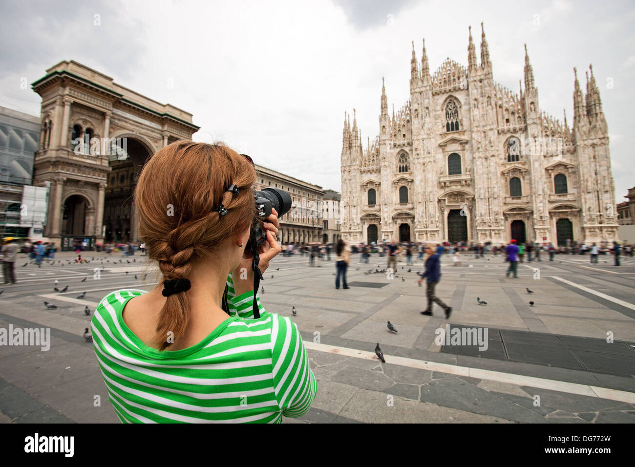 Young woman taking picture of Duomo di Milano (Milan Cathedral), Milan ...