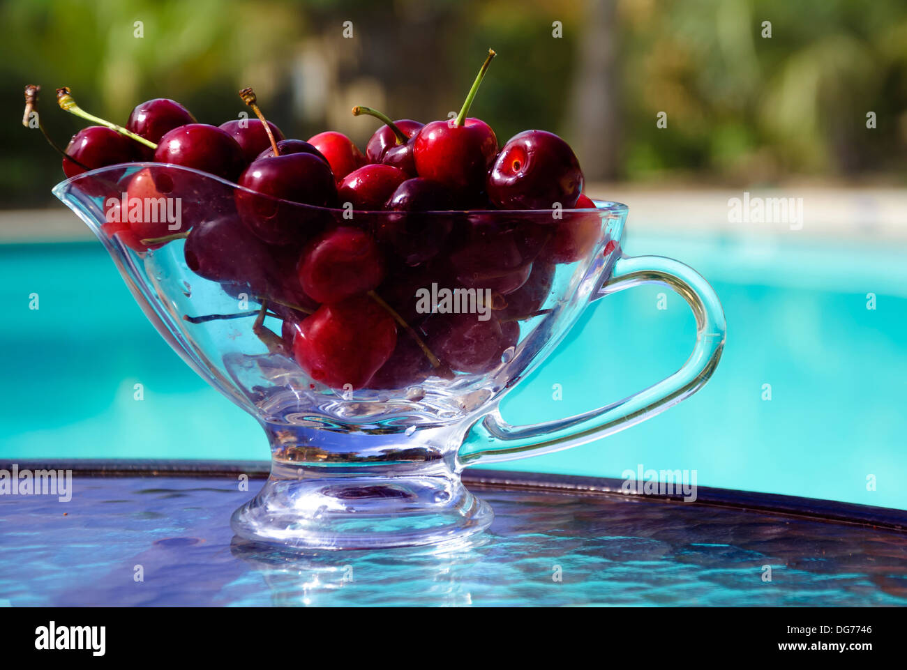 Cherry on the table by the swimming pool Stock Photo - Alamy
