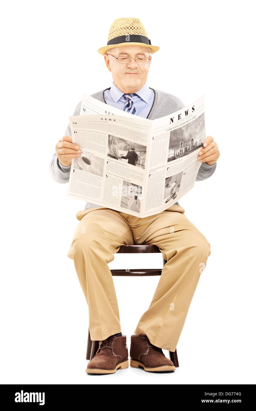 Man sitting on a chair reading a newspaper hi-res stock photography and ...