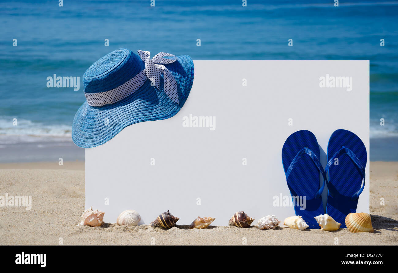 White board with flip-flops, hat and seashells on sandy beach Stock ...