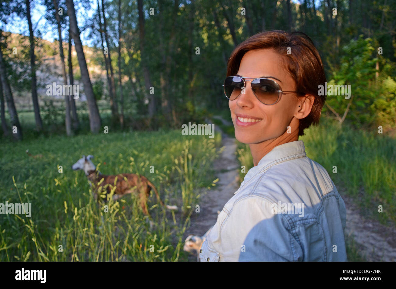 Young attractive woman takes a walk in nature with her dog Stock Photo ...