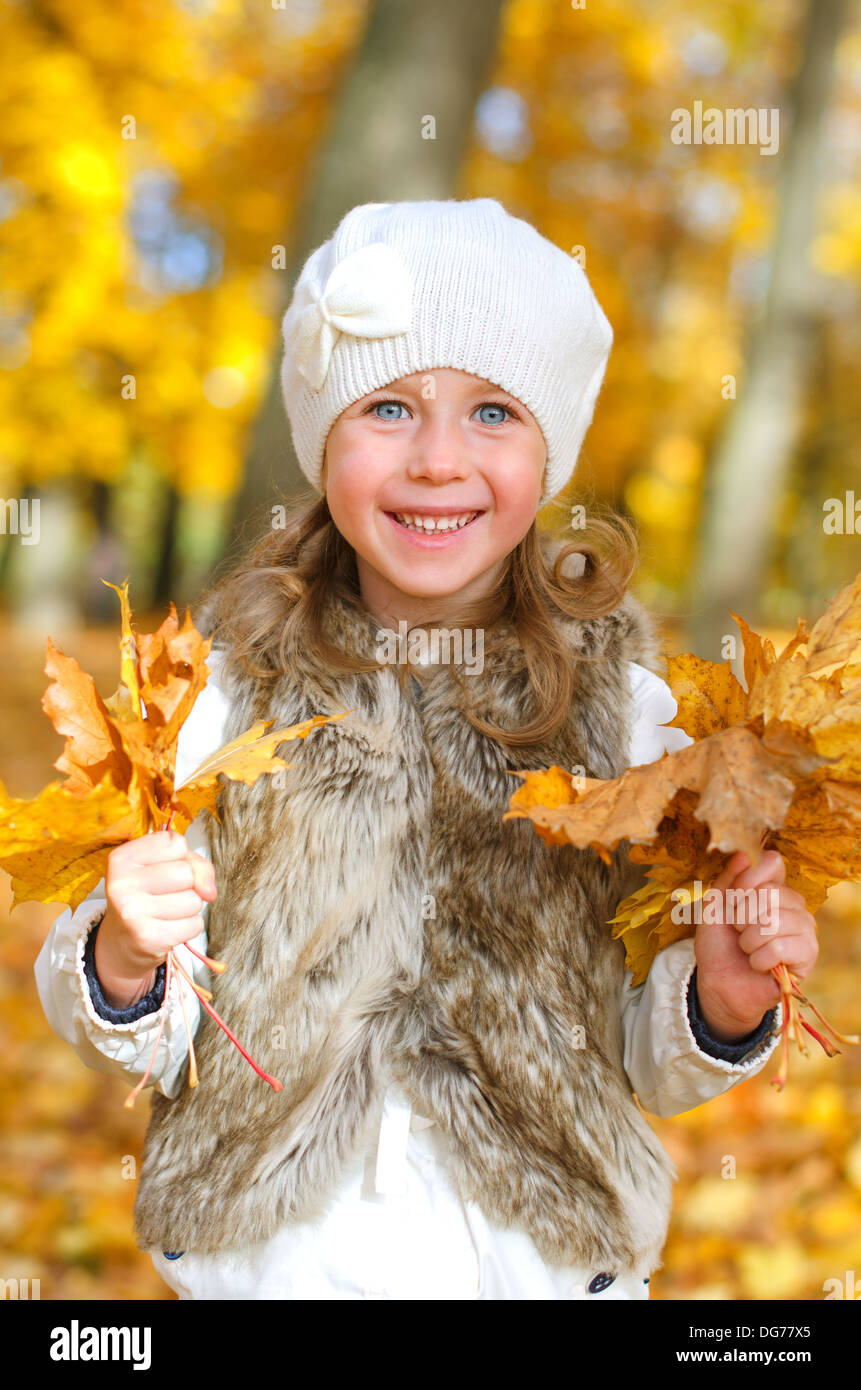 Little girl with fallen autumn leaves Stock Photo - Alamy