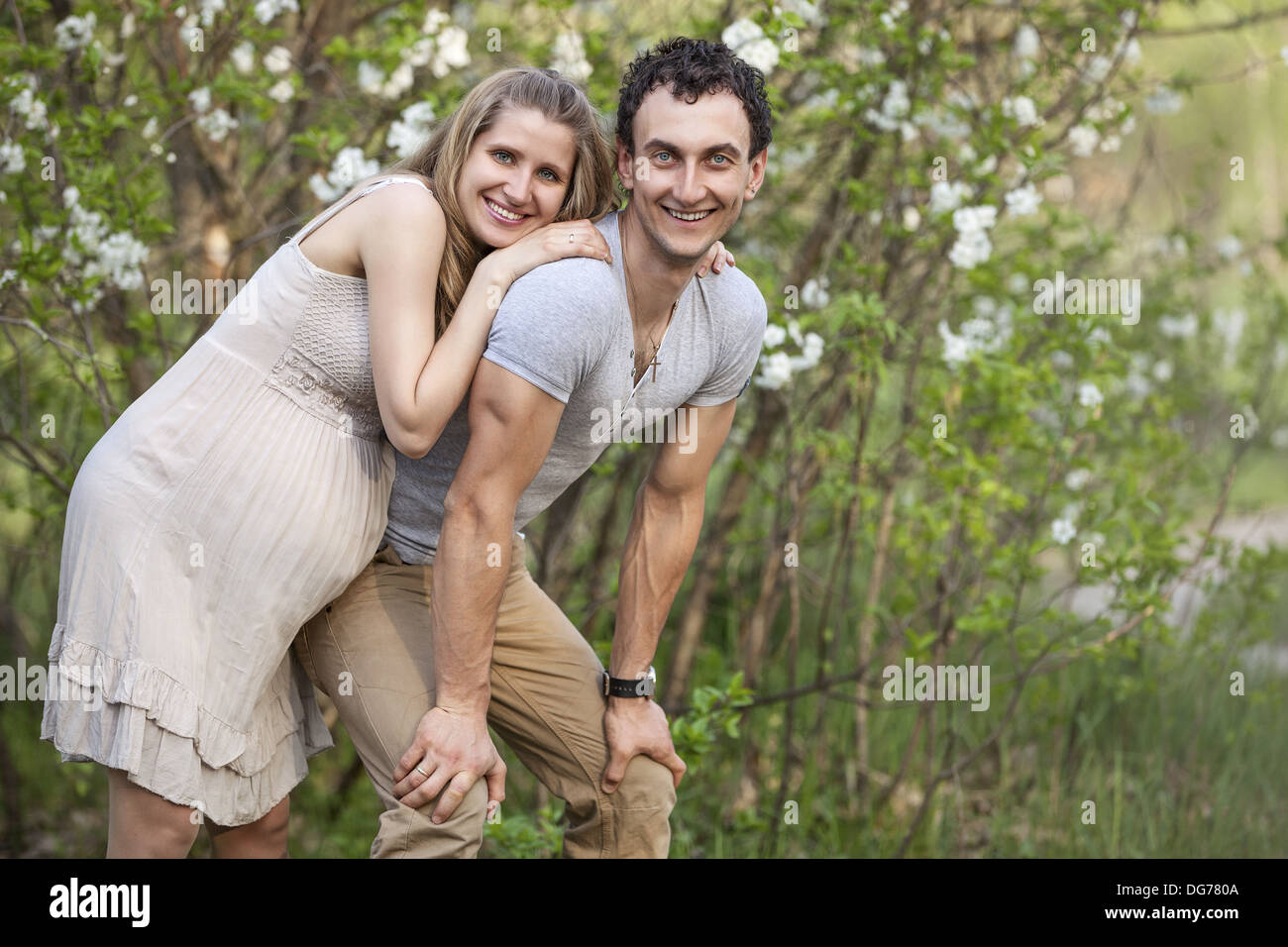 Young pregnant couple outdoors in spring Stock Photo - Alamy