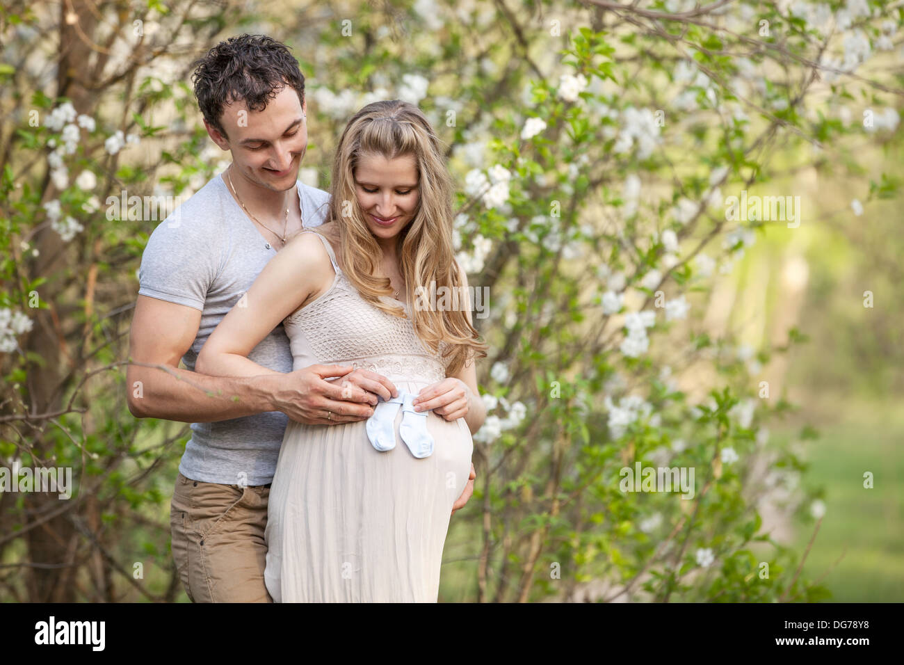 Young pregnant couple outdoors in spring Stock Photo - Alamy